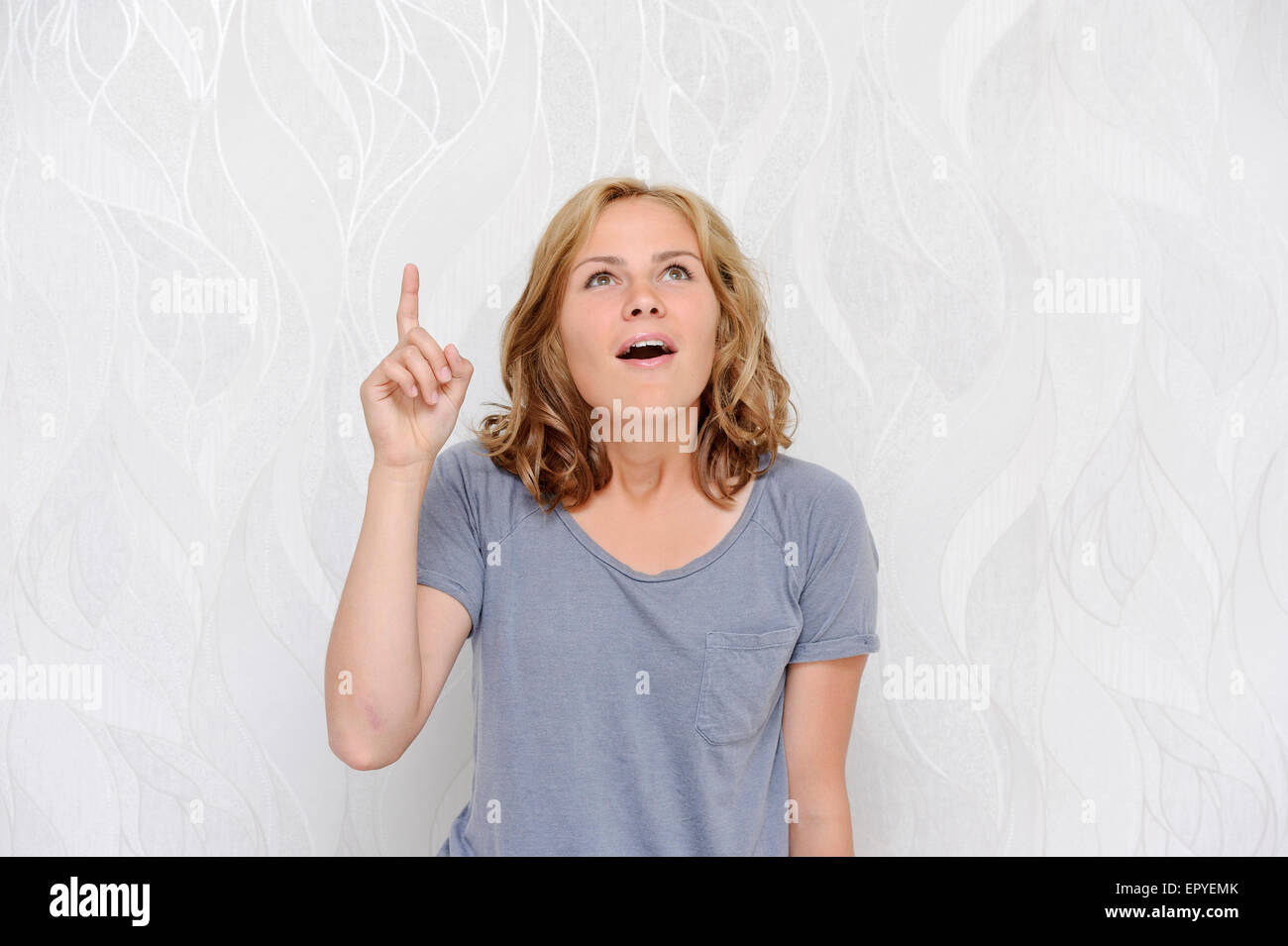 Young woman getting an idea Stock Photo - Alamy