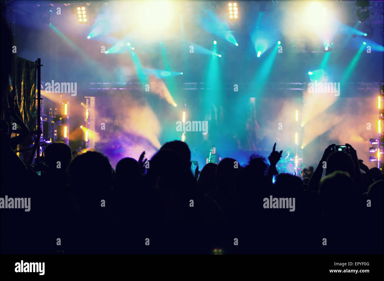 Cheering crowd in front of bright colorful stage lights - retro styled ...
