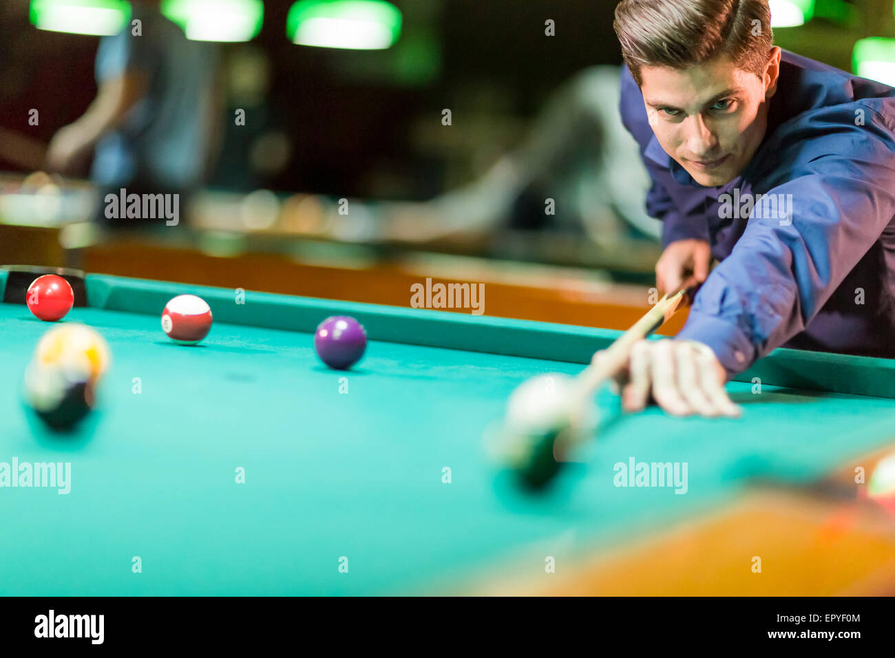 Young man playing pool Stock Photo - Alamy