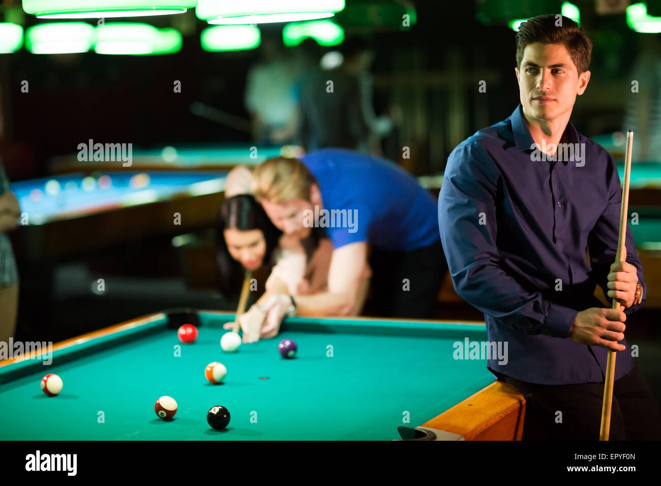 Young people playing pool Stock Photo - Alamy