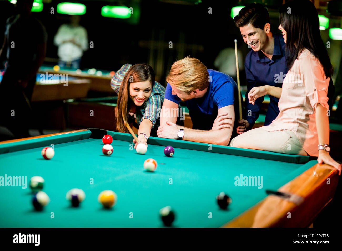 Young people playing pool Stock Photo - Alamy