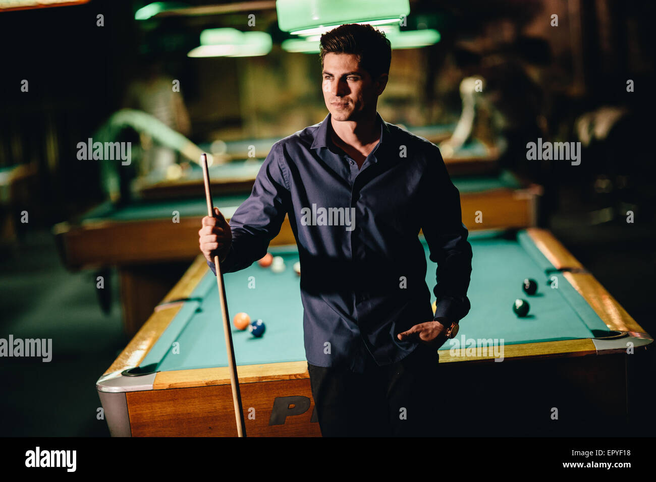Young man playing pool Stock Photo - Alamy