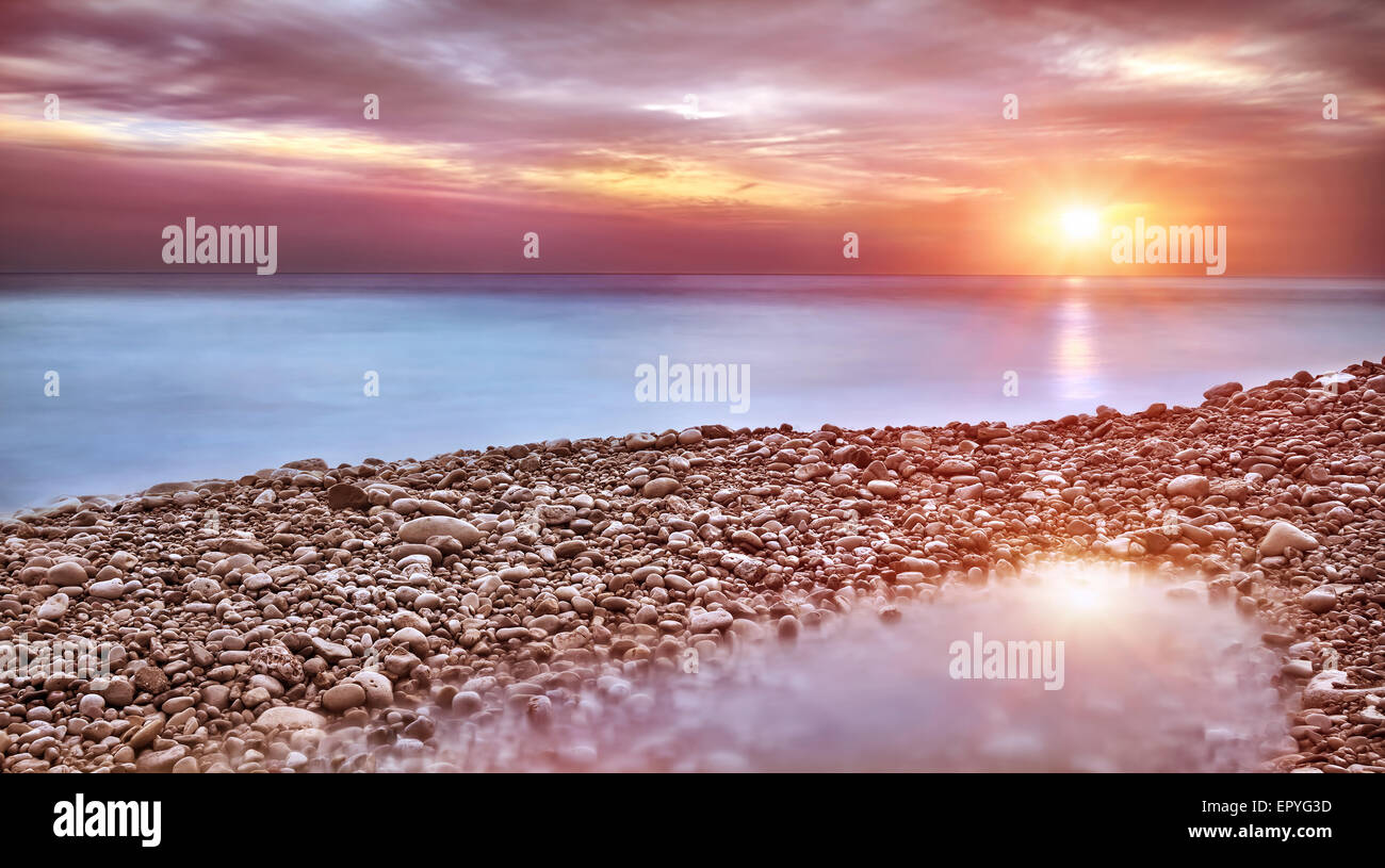 Beautiful beach landscape, amazing view on pebble coast in mild sunset ...