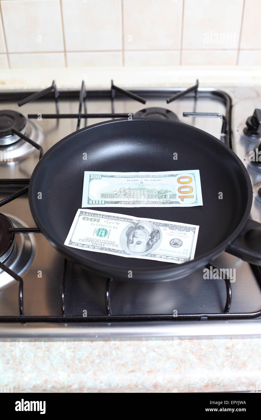 hundred dollar bills in a frying pan Stock Photo - Alamy
