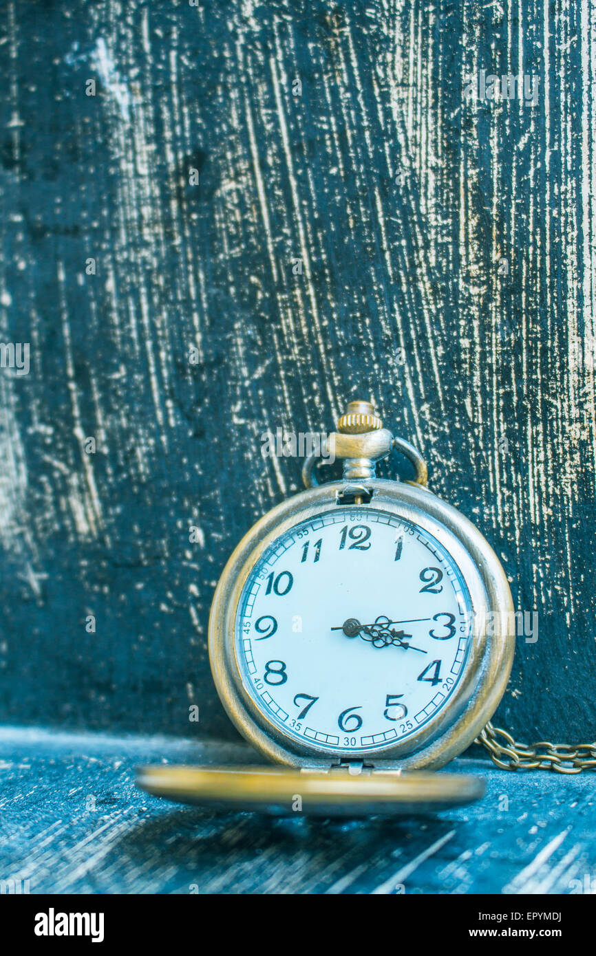 Classic clock on a wooden background Stock Photo - Alamy