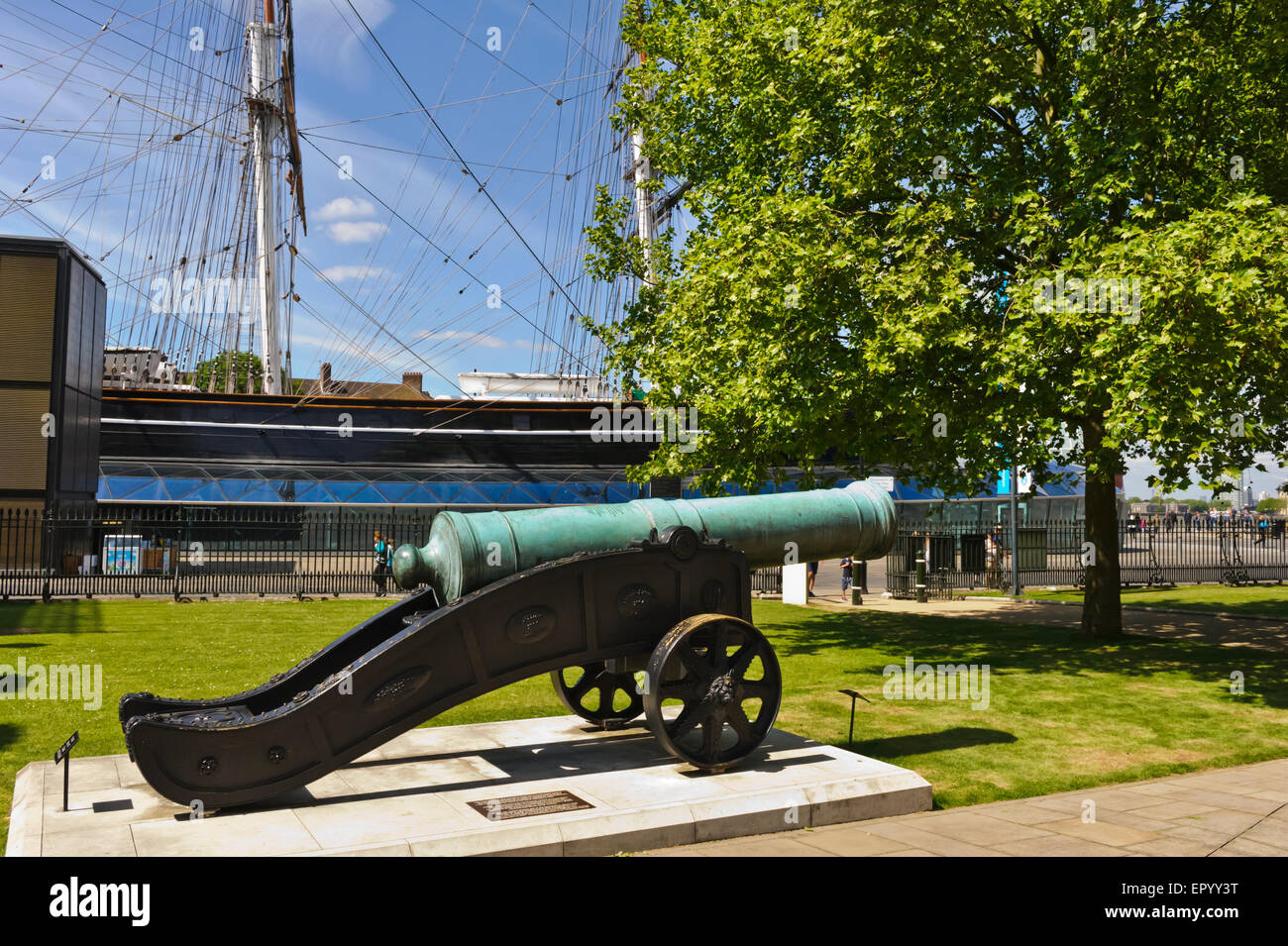 An old cannon with the 'Cutty Sack' ship in the distance in Greenwich ...