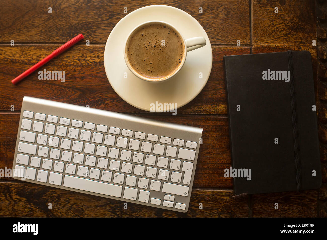 Computer keyboard, Cup of coffee, a notebook and red pencil on the ...