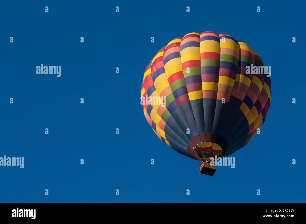 Hot Air balloon lifting off from field at sunrise Stock Photo - Alamy