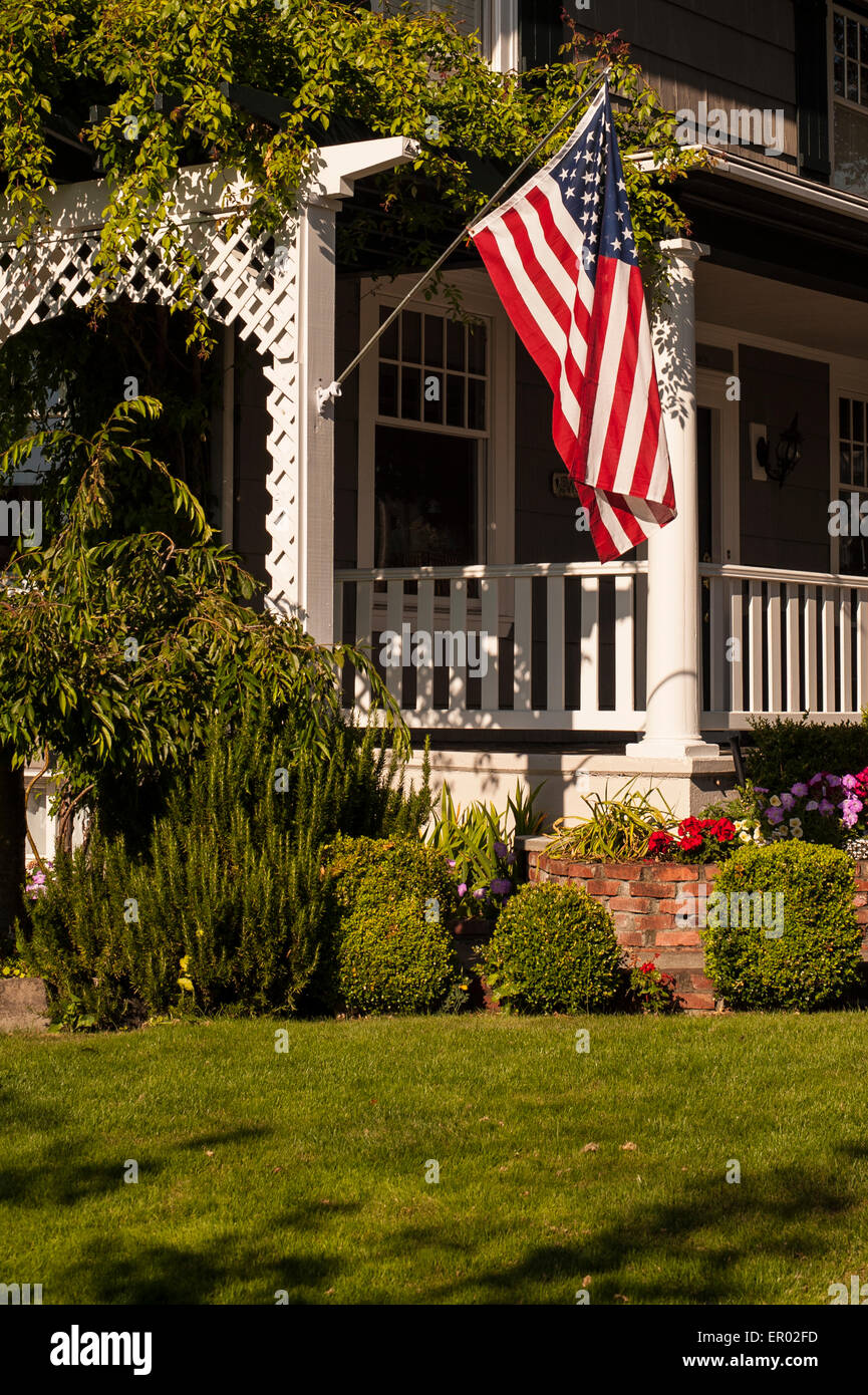Home with American Flag on porch with yard and ideal neigborhood rural ...