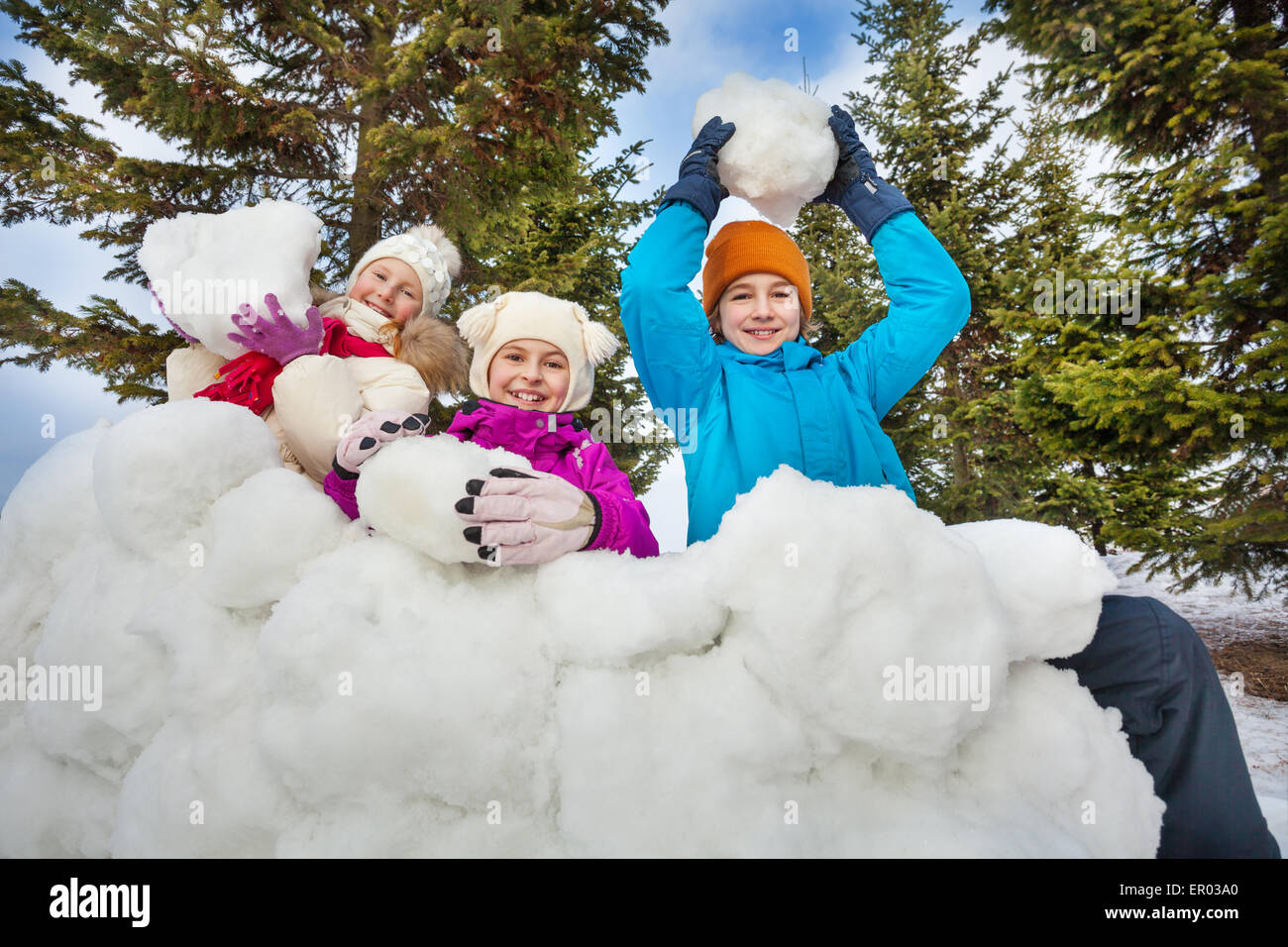 Group of happy children hold snowballs to play Stock Photo - Alamy