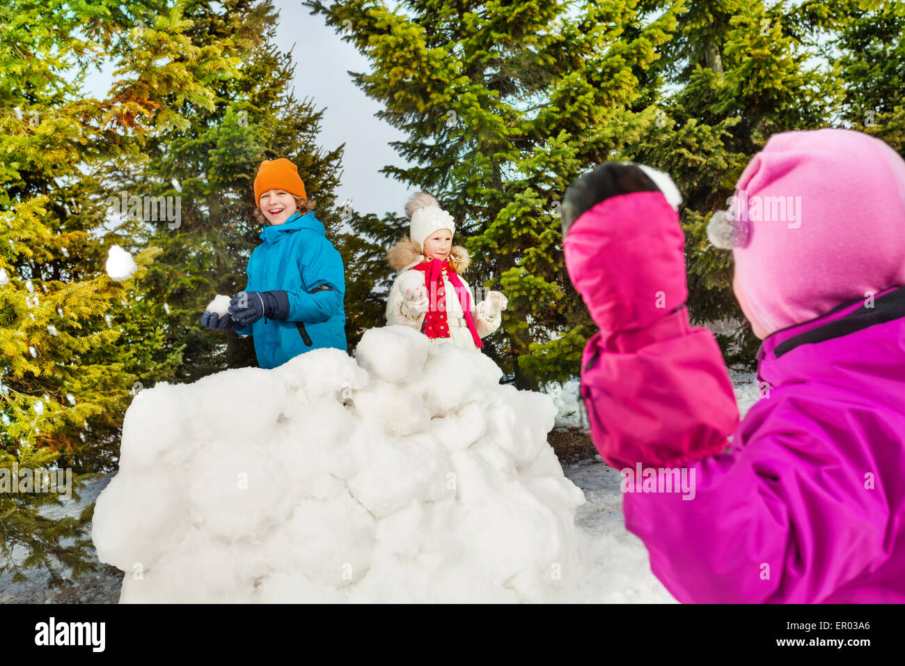 Back of girl throw snowball while playing game Stock Photo - Alamy