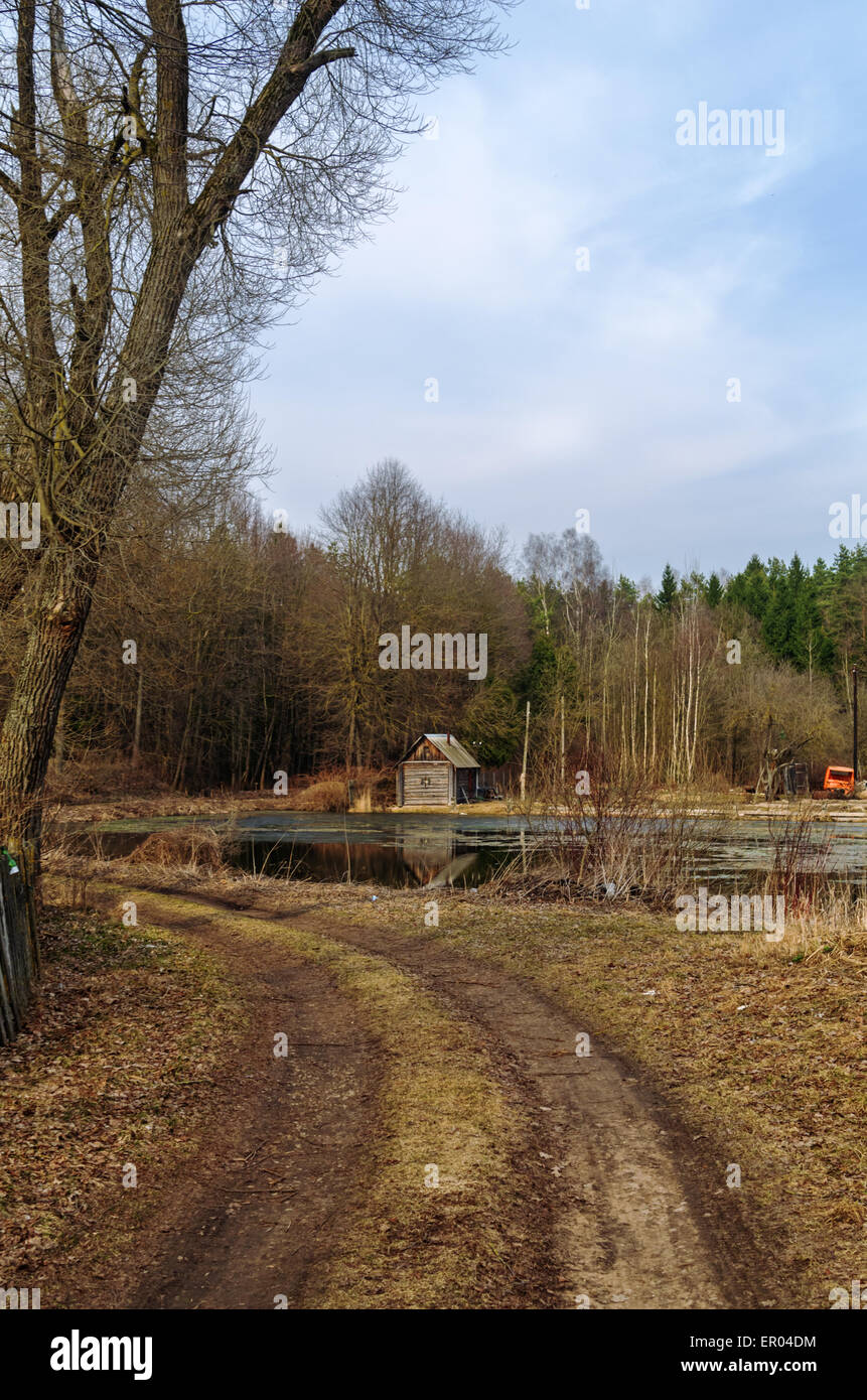 Rural spring road in village Stock Photo - Alamy