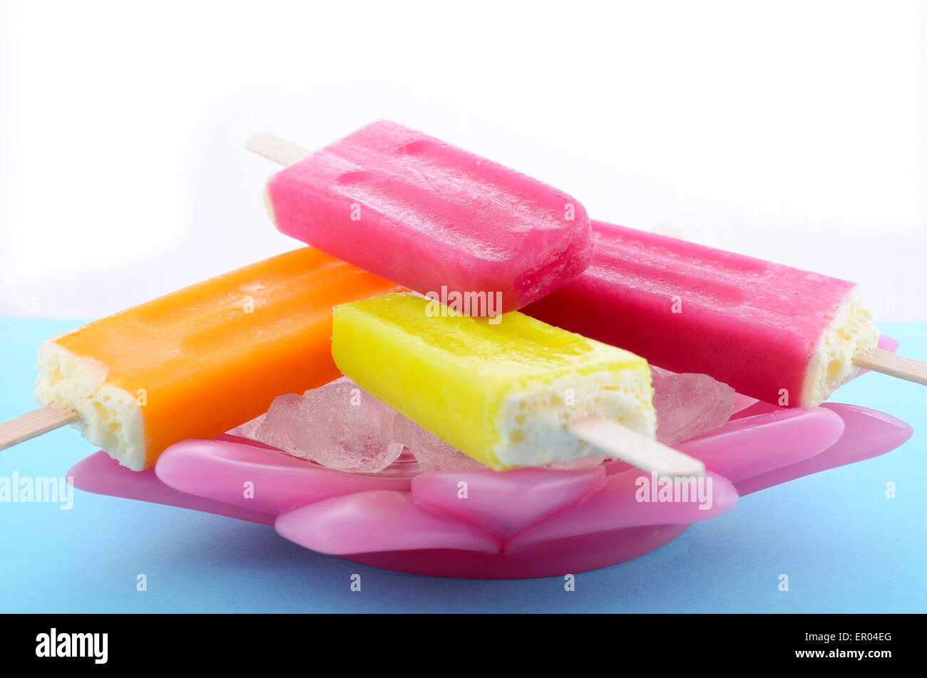 Summer is Here concept with bright color ice pop, ice creams on ice in ...