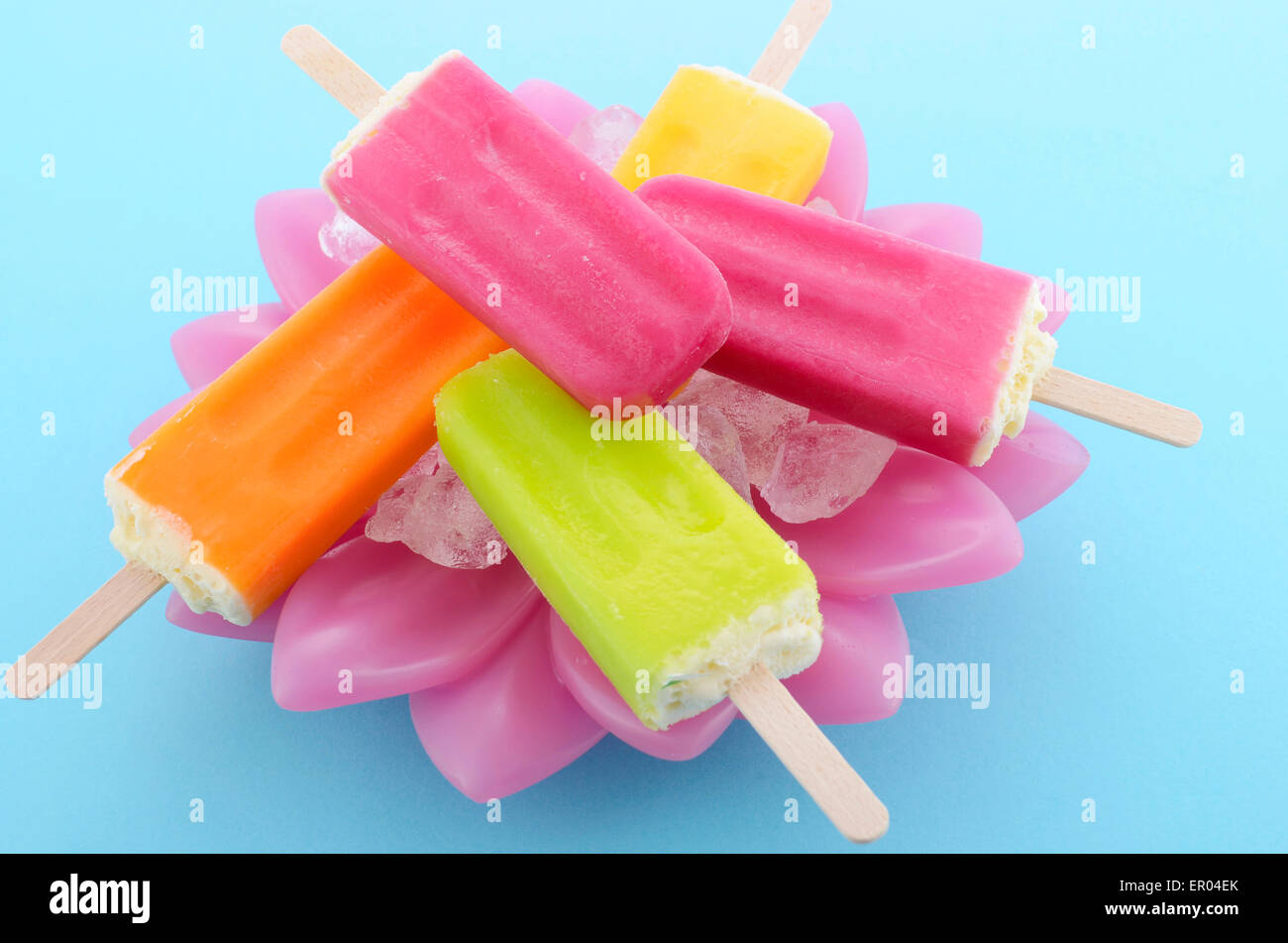 Summer is Here concept with bright color ice pop, ice creams on ice in ...