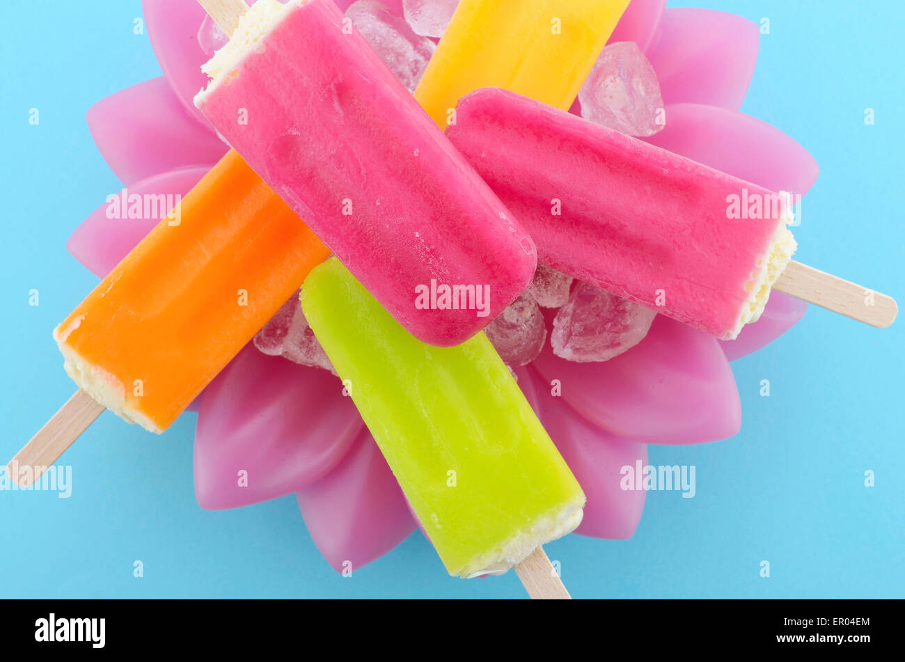 Summer is Here concept with bright color ice pop, ice creams on ice in ...