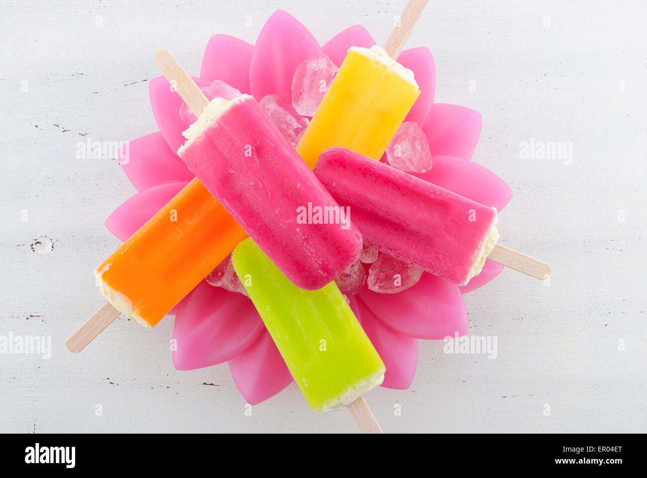 Summer is Here concept with bright color ice pop, ice creams on ice in ...