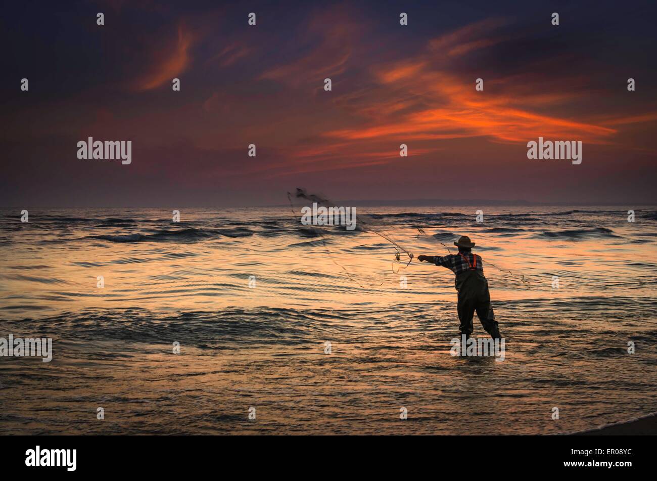The fisherman throwing the net Stock Photo - Alamy