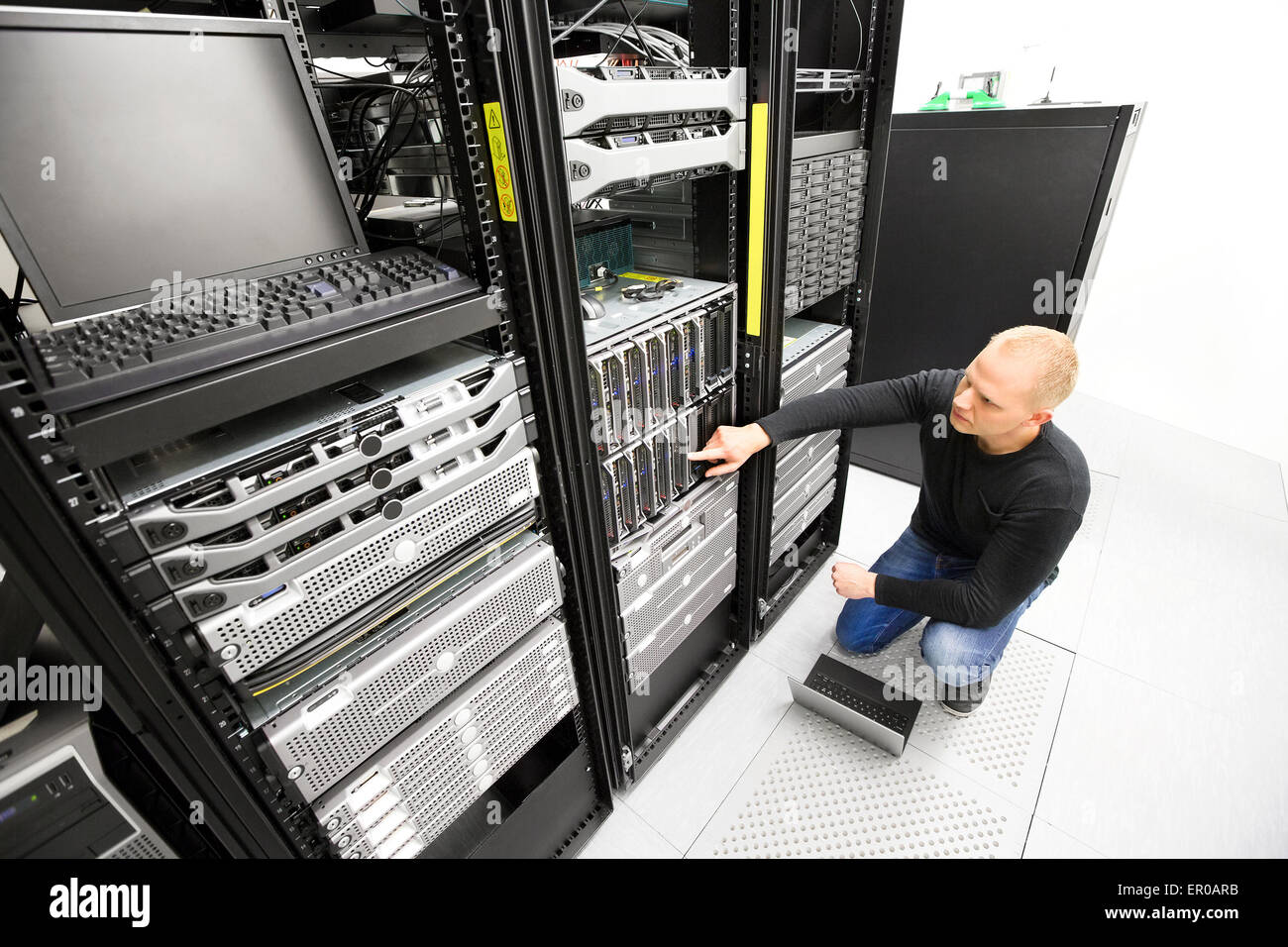 It consultant monitors servers in datacenter Stock Photo - Alamy
