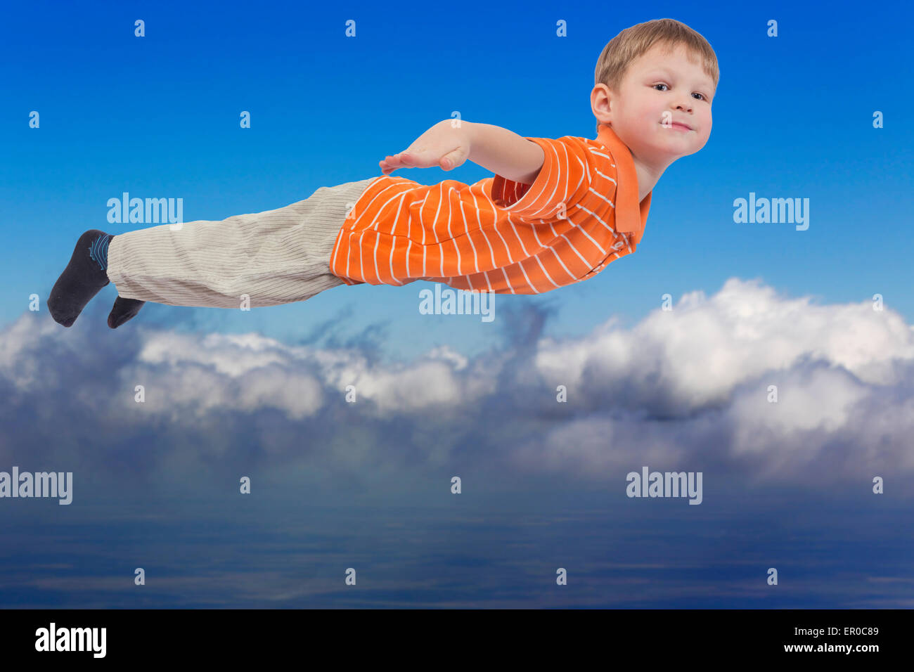 Young boy flying and cloud sky in background Stock Photo - Alamy