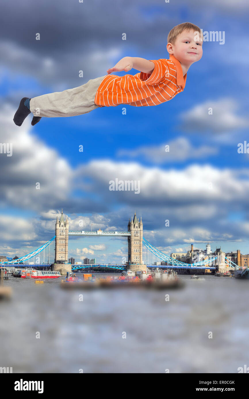 Young boy flying with Tower bridge London UK in background Stock Photo ...