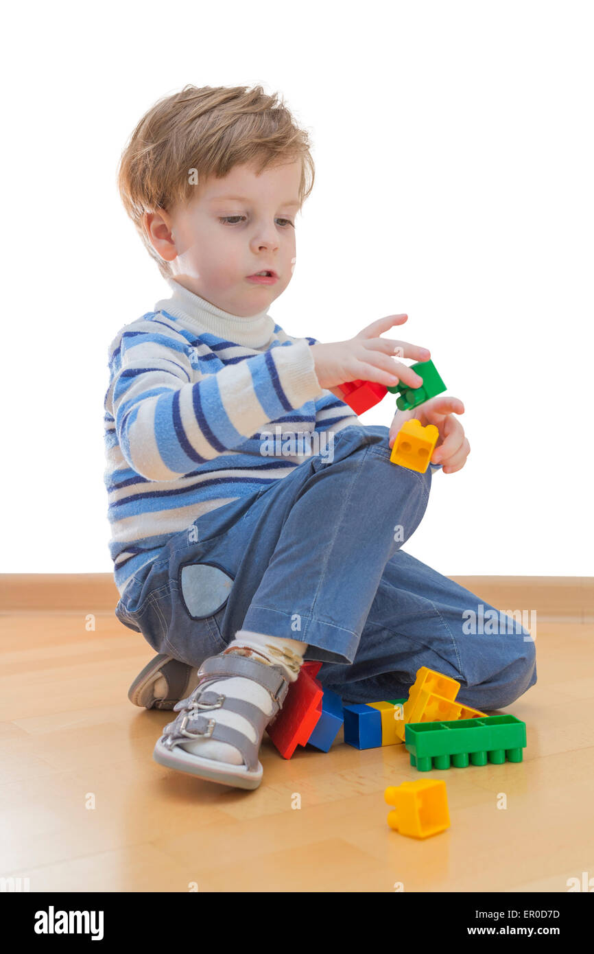 Boy playing with plastic construction white background Stock Photo - Alamy