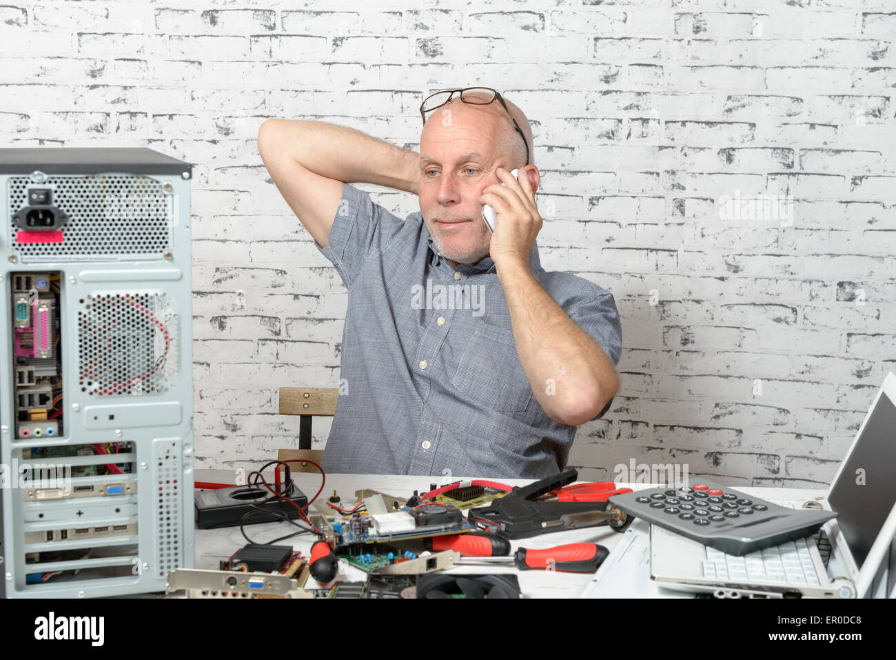 a technician repairing a computer with different tools Stock Photo - Alamy