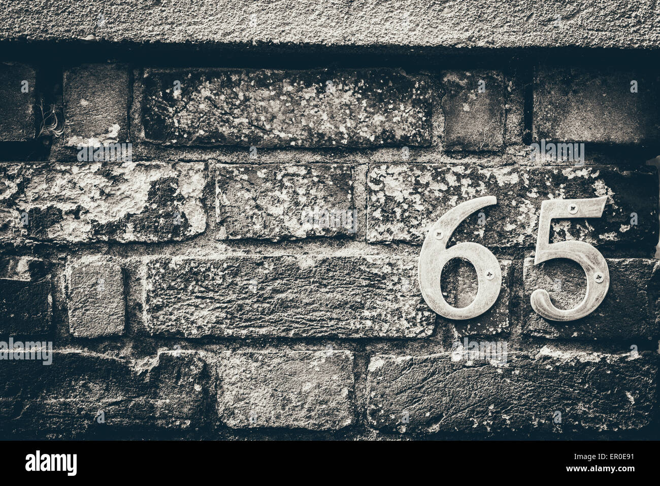 House number 65 sixty five closeup on a brick wall Stock Photo - Alamy