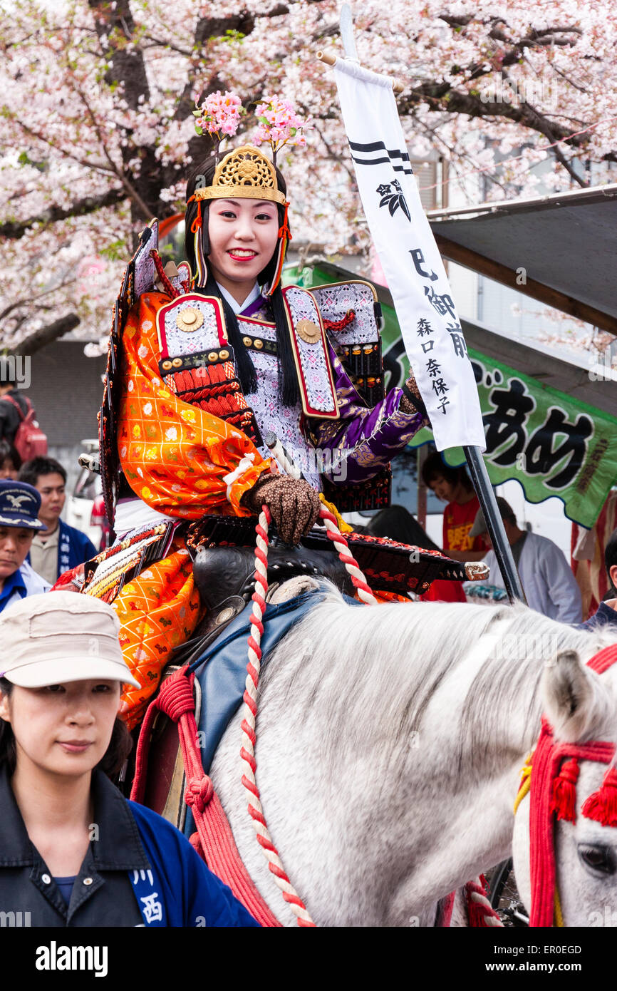 Young woman dressed in Heian period costume of a samurai with a mae ...