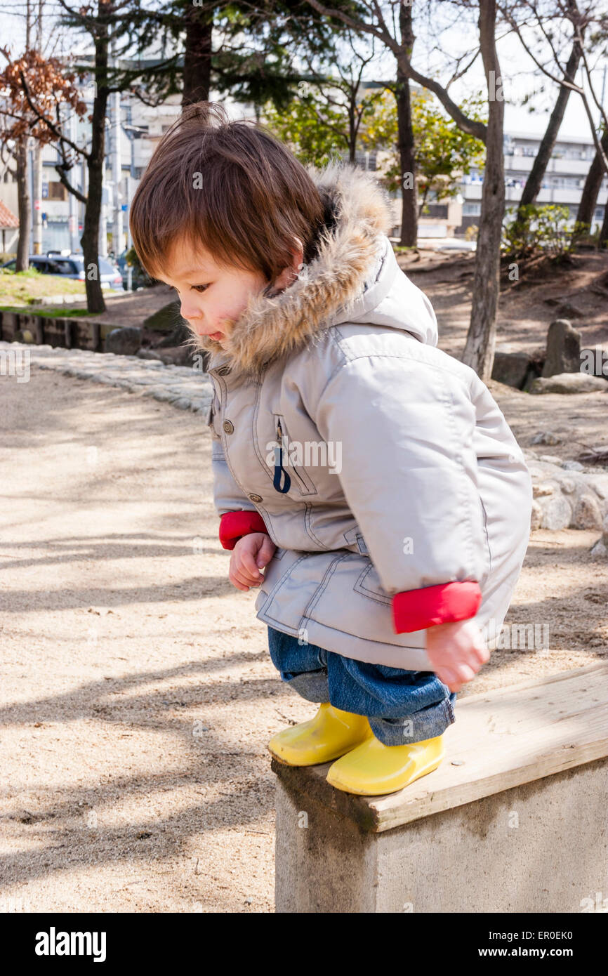 Child, boy, 3-4 year old, outdoors in cold weather, wearing thick coat ...