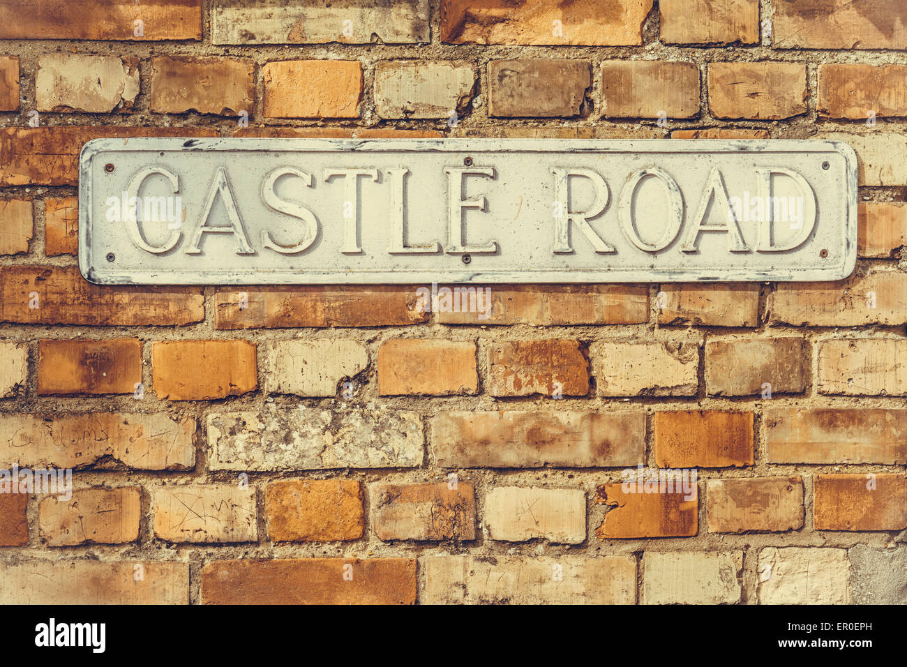 'Castle Road' sign on a weathered wall vintage look weathered wall ...