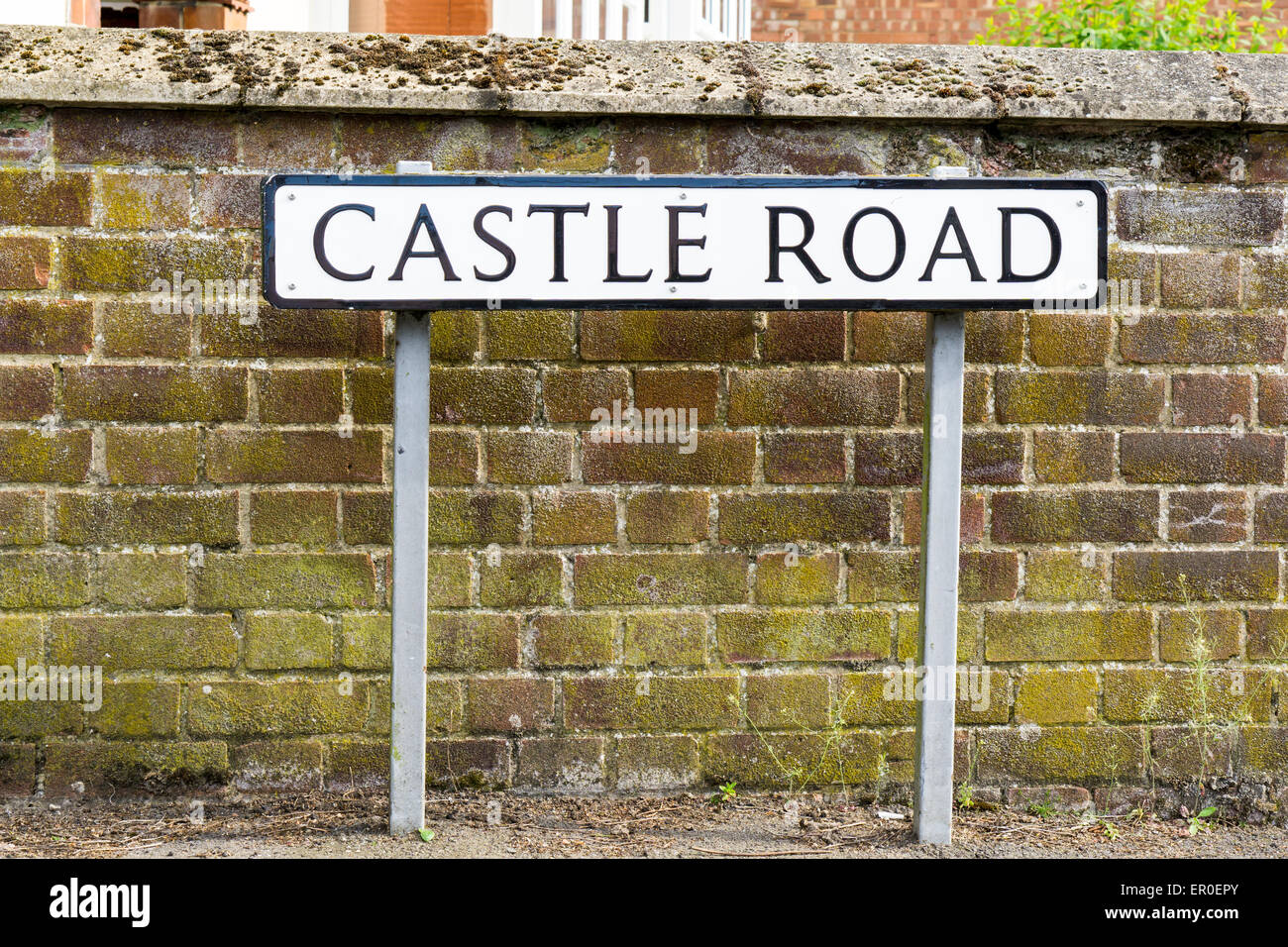 'Castle Road' sign on a street corner against a weathered wall closeup ...