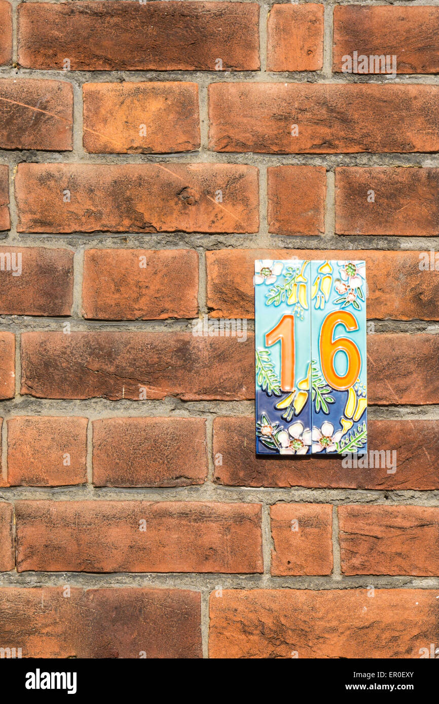 House number 16 sixteen weathered wall closeup Stock Photo - Alamy
