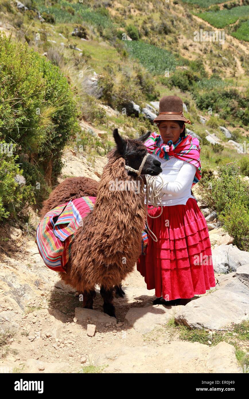 Local lady with llama on the Isla del Sol (Island of the Sun), the ...