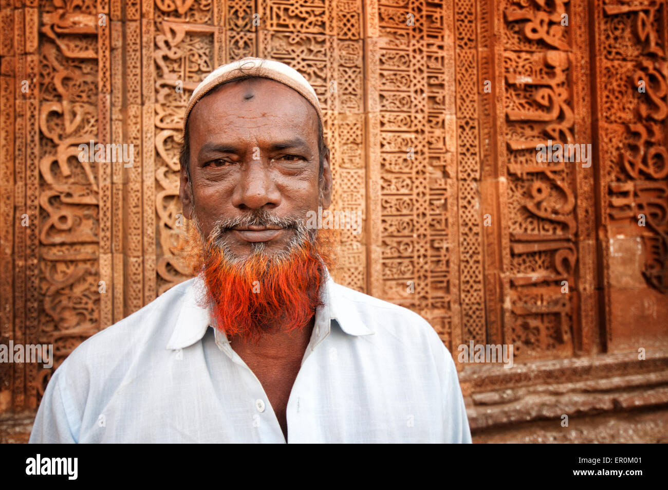 Indian man with red beard in front of Adhai-din-ka-Jhonpra ruins in a ...