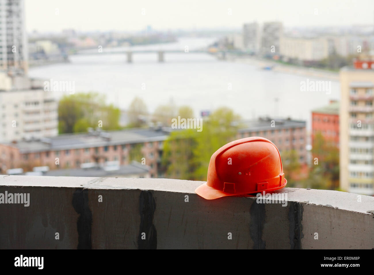 Construction. Construction helmet on the window of an unfinished house ...