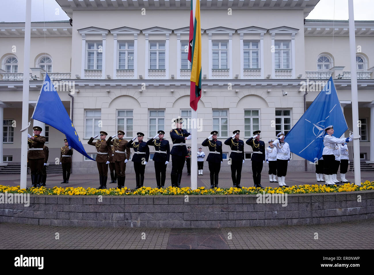 Lithuanian military men raising flags of the North Atlantic Treaty ...
