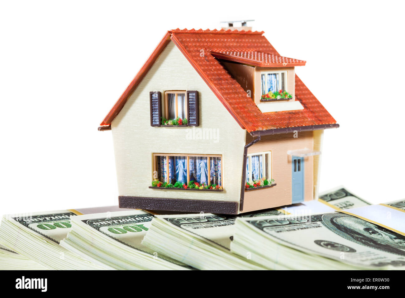 house on packs of banknotes isolated on white background Stock Photo ...