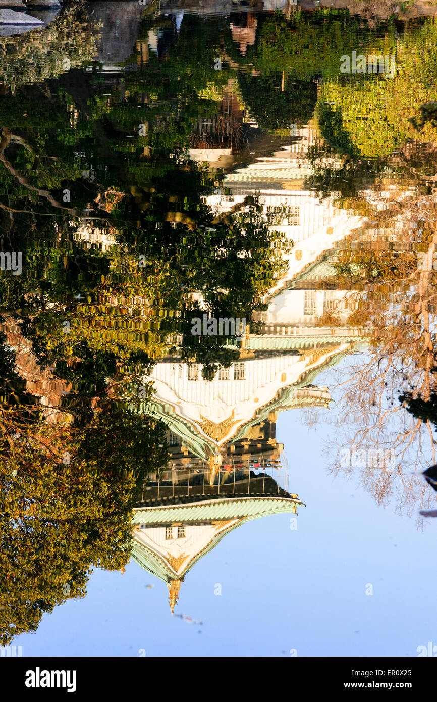 Reflection of Osaka castle keep, borogata style with trees around it ...