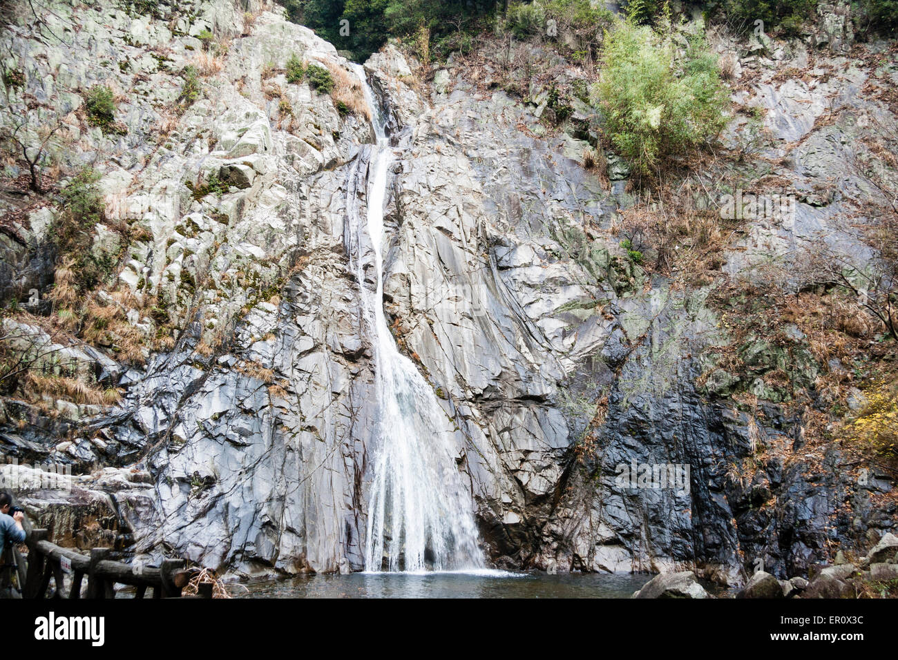 The Nunobiki waterfall, men-daki, plunging down rock face into large ...