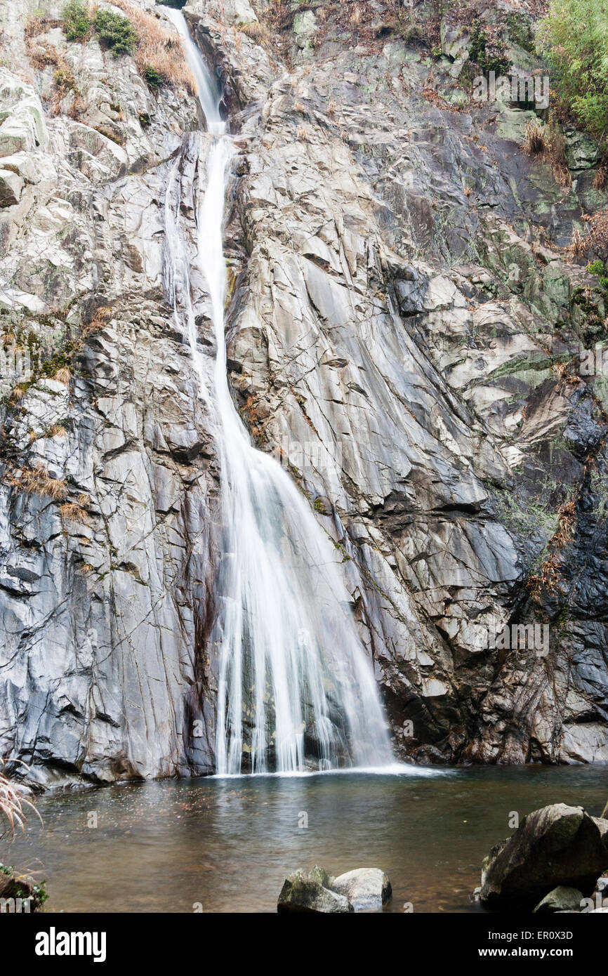 The Nunobiki waterfall, men-daki, plunging down rock face into large ...