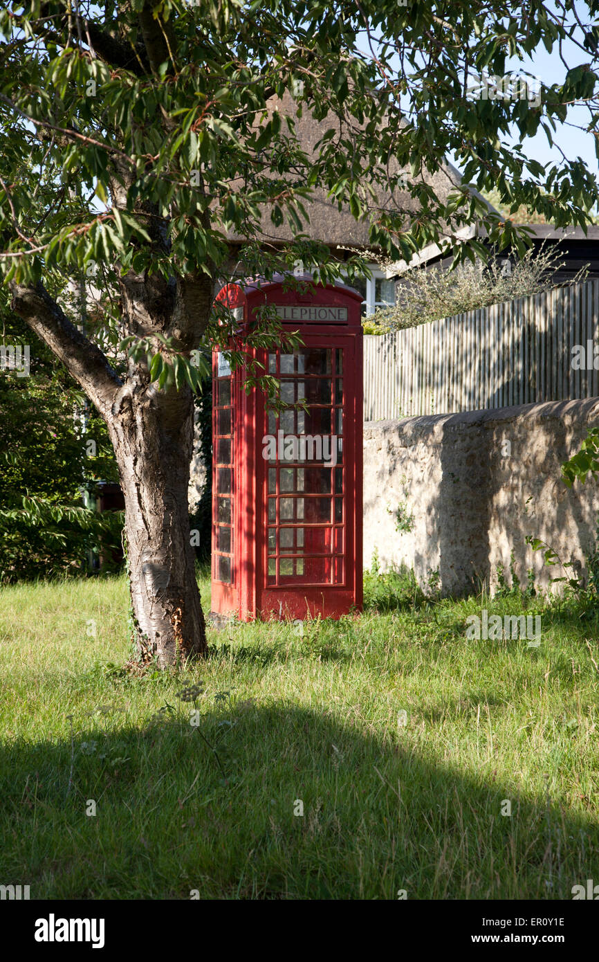 British red telephone box in a village setting Stock Photo - Alamy