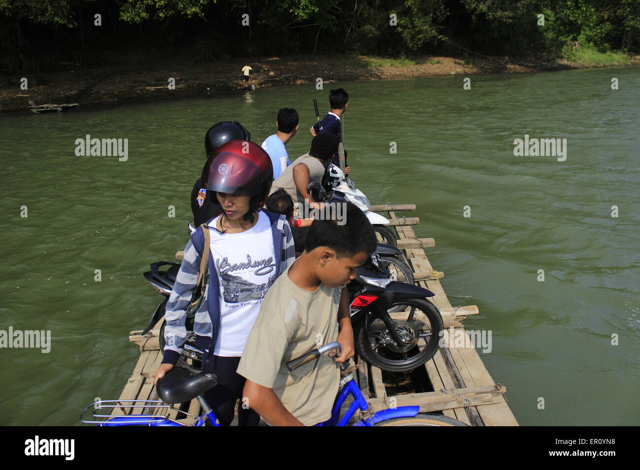 Kulon Progo, Indonesia. 24th May, 2015. Resident cross the river using ...