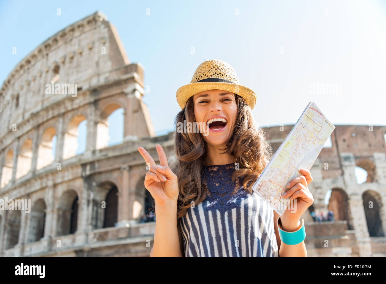On a sunny summer's day, a laughing female tourist stands near the ...