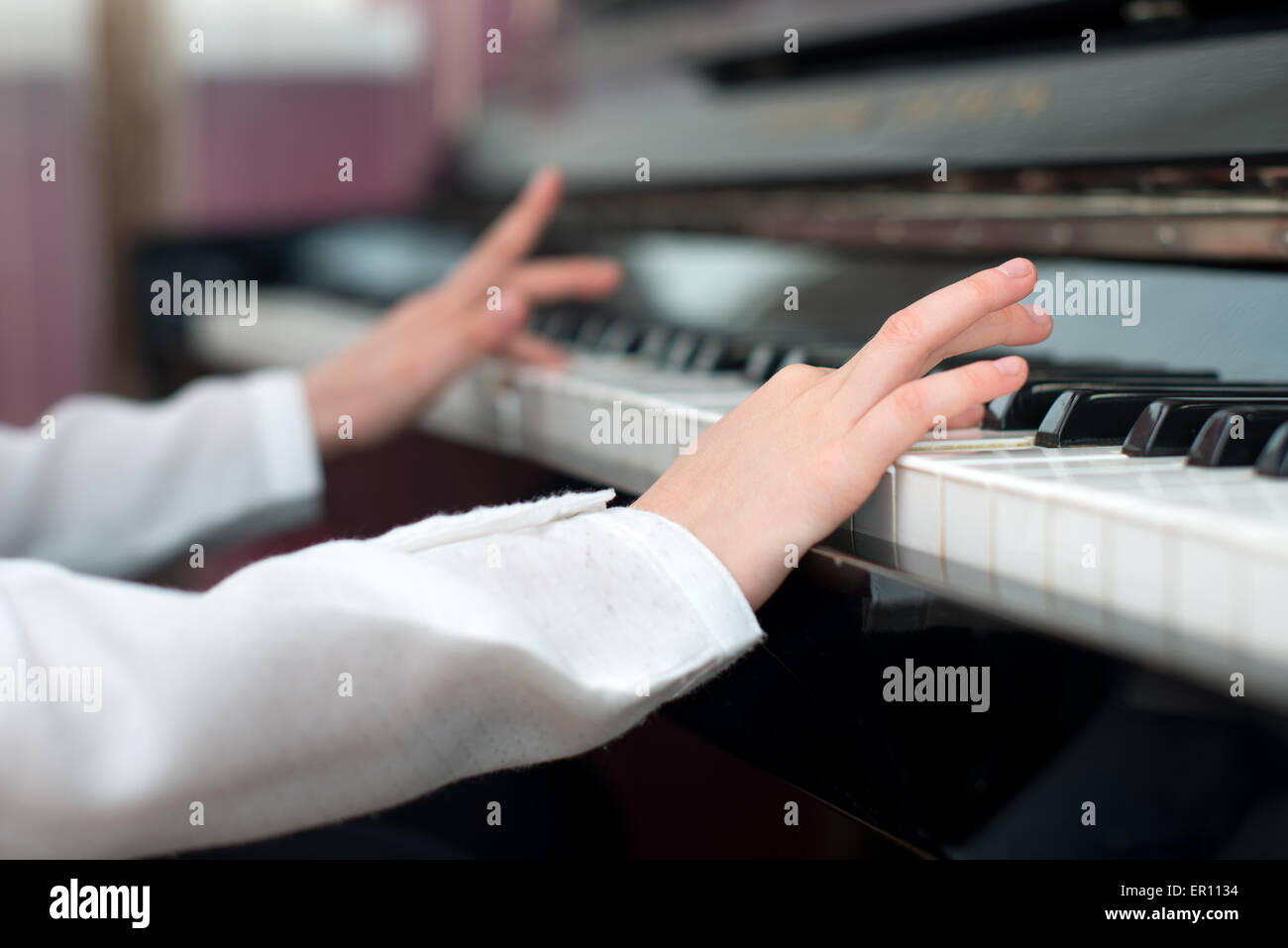 Child learning to play the piano Stock Photo - Alamy