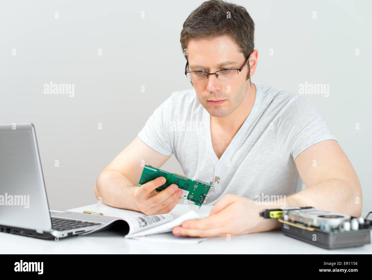 Male technician reading manual at his workplace Stock Photo - Alamy