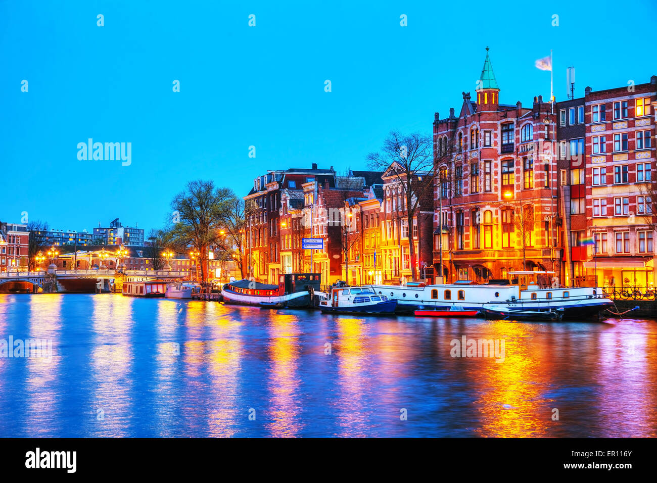 Night city view of Amsterdam, the Netherlands with the Amstel river ...