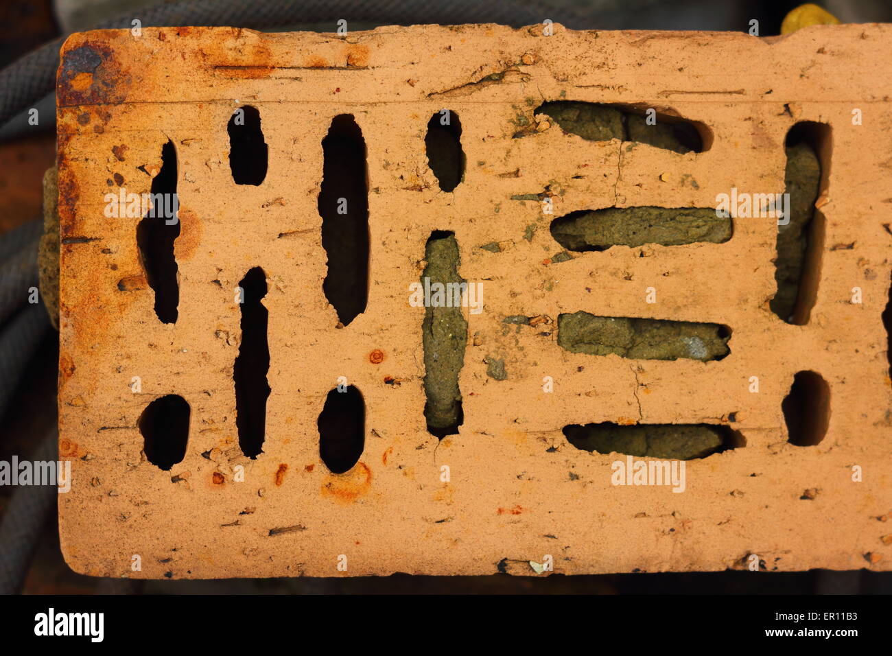 old hollow brick with holes of various shapes Stock Photo - Alamy