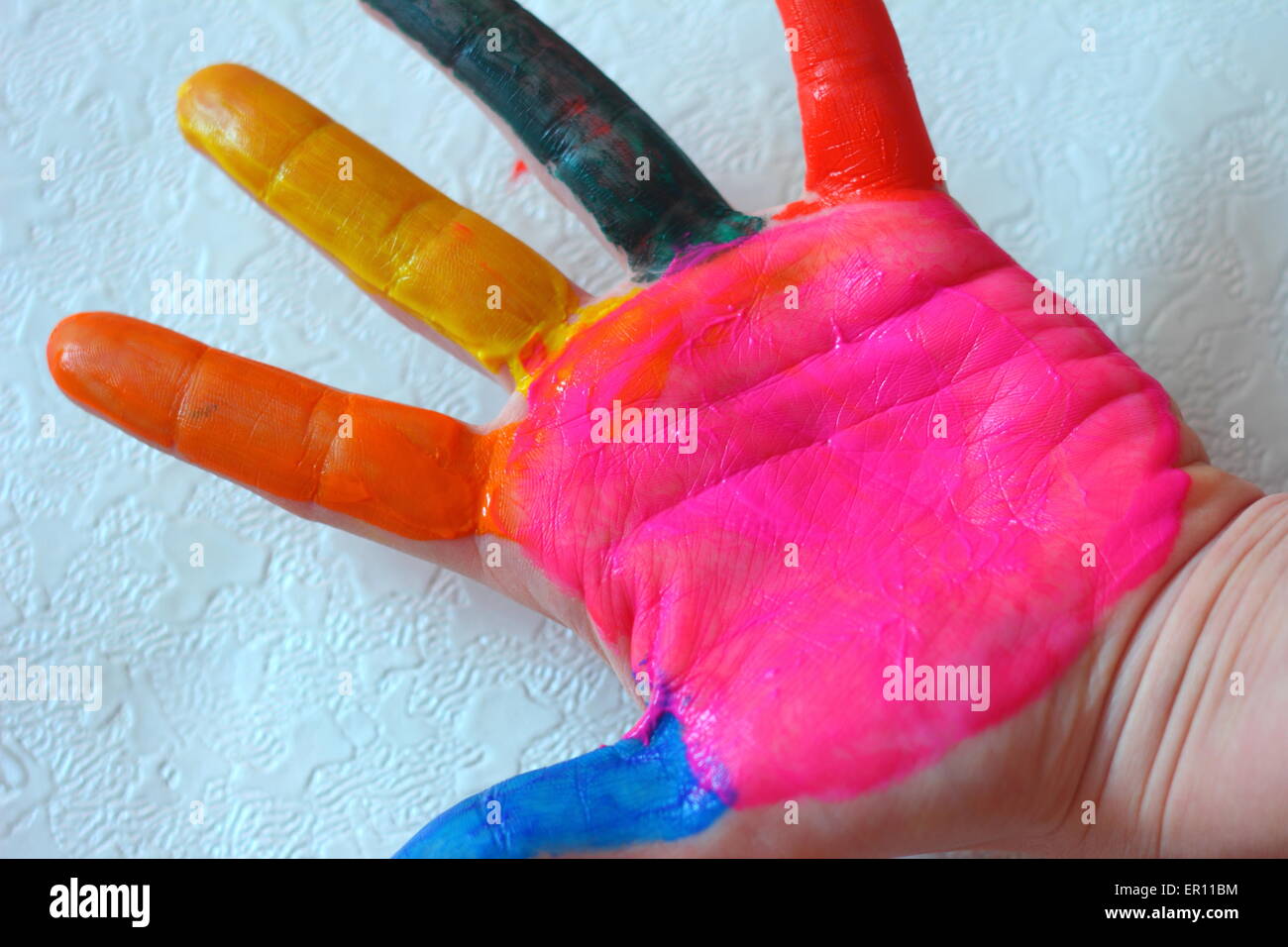 hand in a different color paints Stock Photo - Alamy