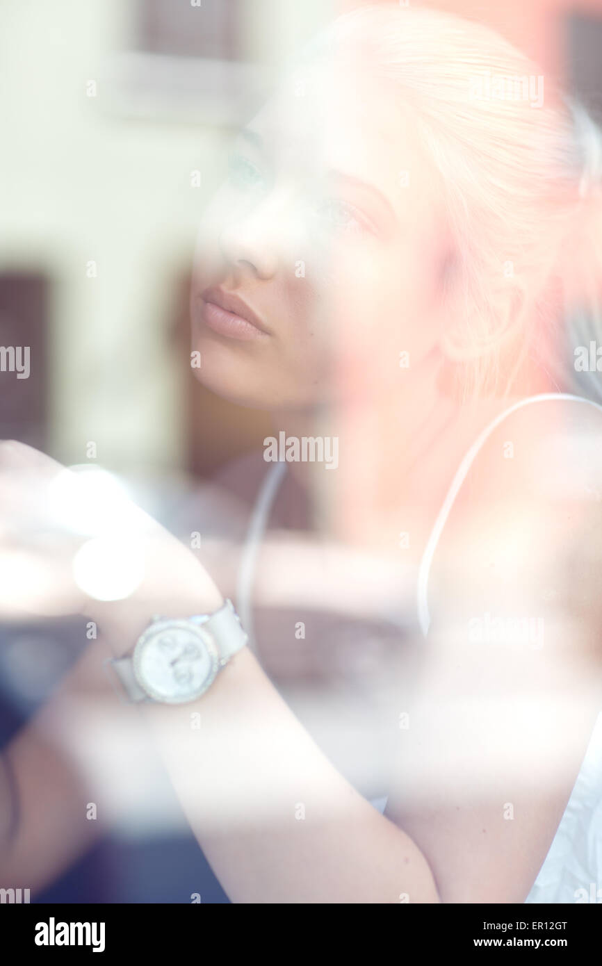 Beautiful teenage girl behind window Stock Photo - Alamy