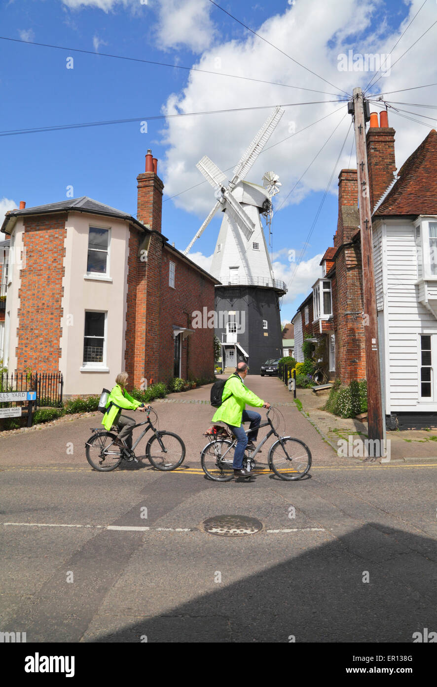 Two cyclists riding by the Union Windmill in Cranbrook, Kent, England ...